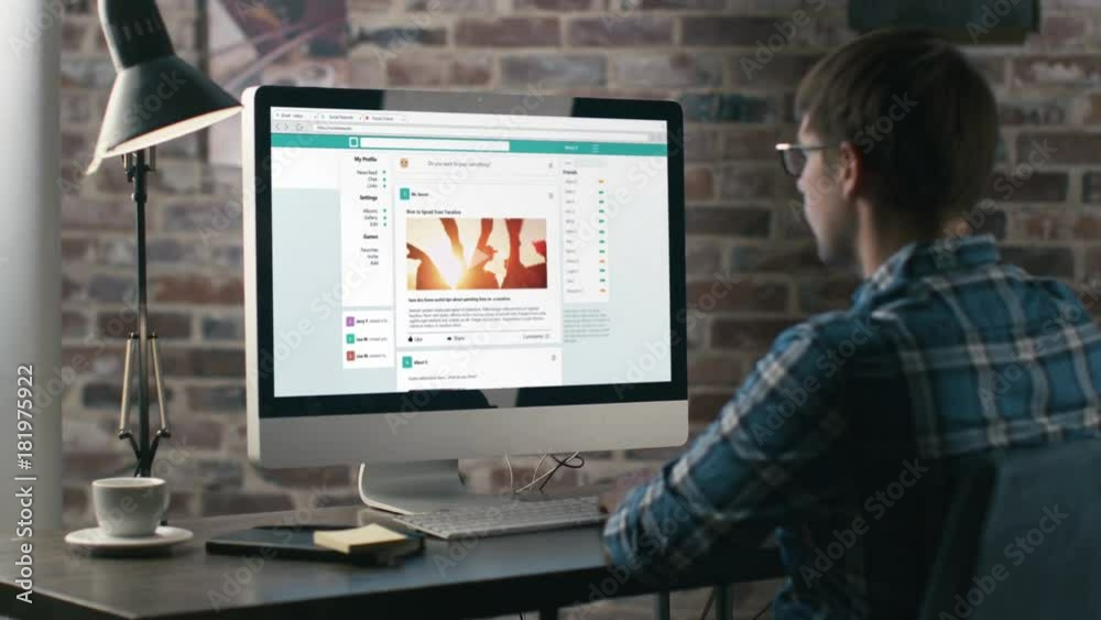 Young Man at His Personal Computer Browses Through Social Network ...