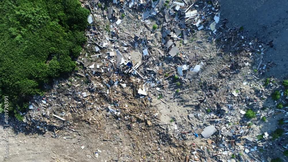 Aerial top down view moving up above landfill site also known as tip ...