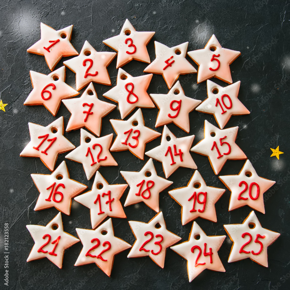 Advent calendar from gingerbread star cookies. Numbers from 1 to 25 on ...