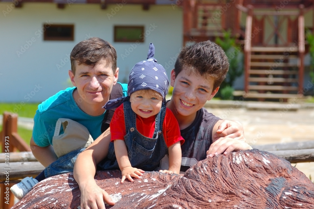 Father and two sons rest in a tourist complex in the mountains Stock ...