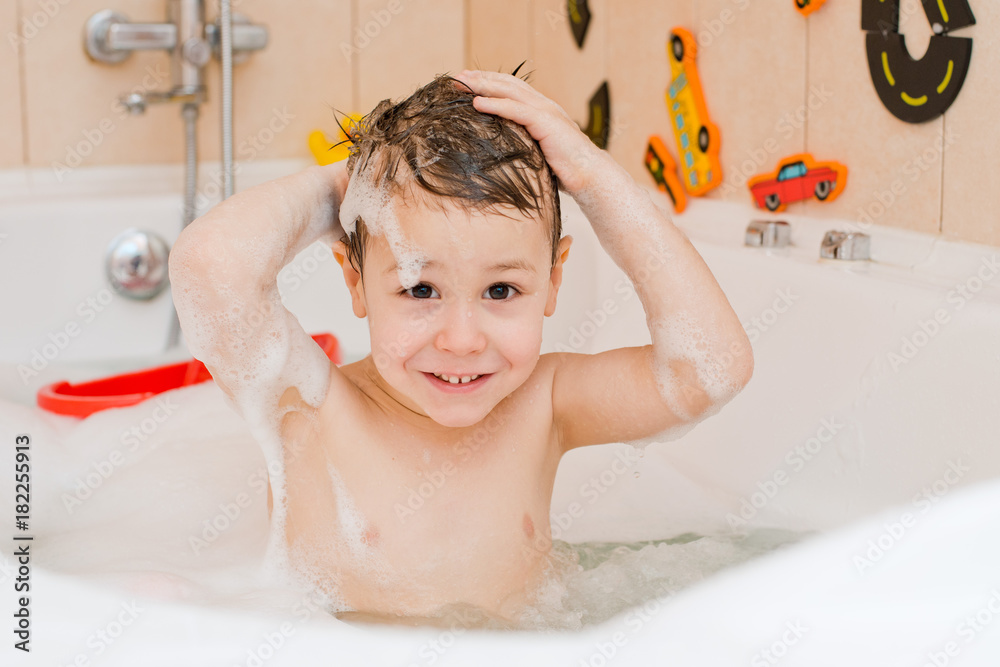 a child taking a bath with foam Stock Photo | Adobe Stock