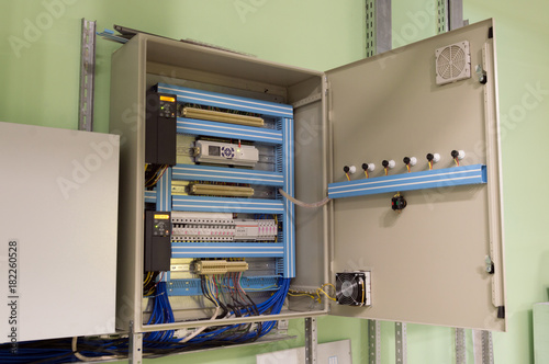 Opened ventilation system control box on the wall of the industrial ...