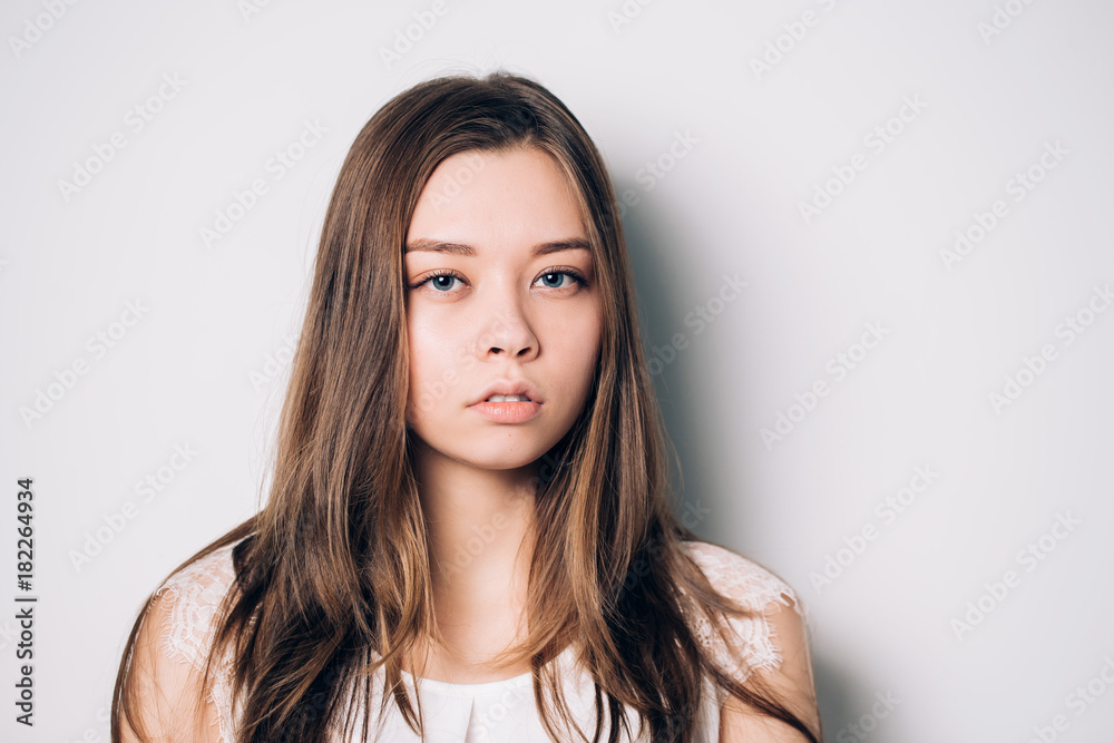 young beautiful sad woman serious and concerned looking worried and ...