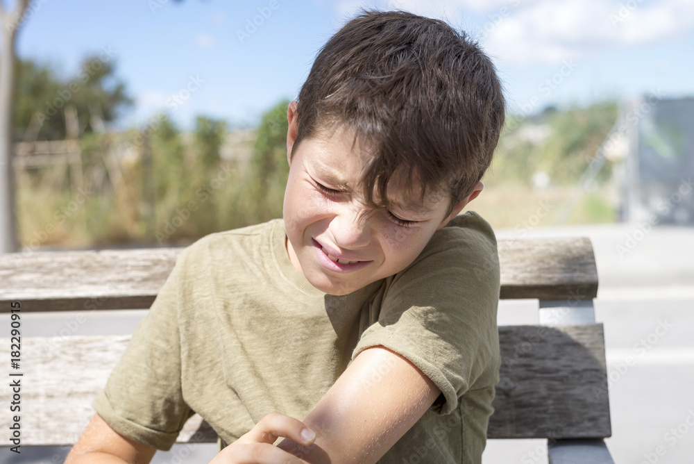 Full body of asian child injured at elbow. Sad boy groaning with Stock ...