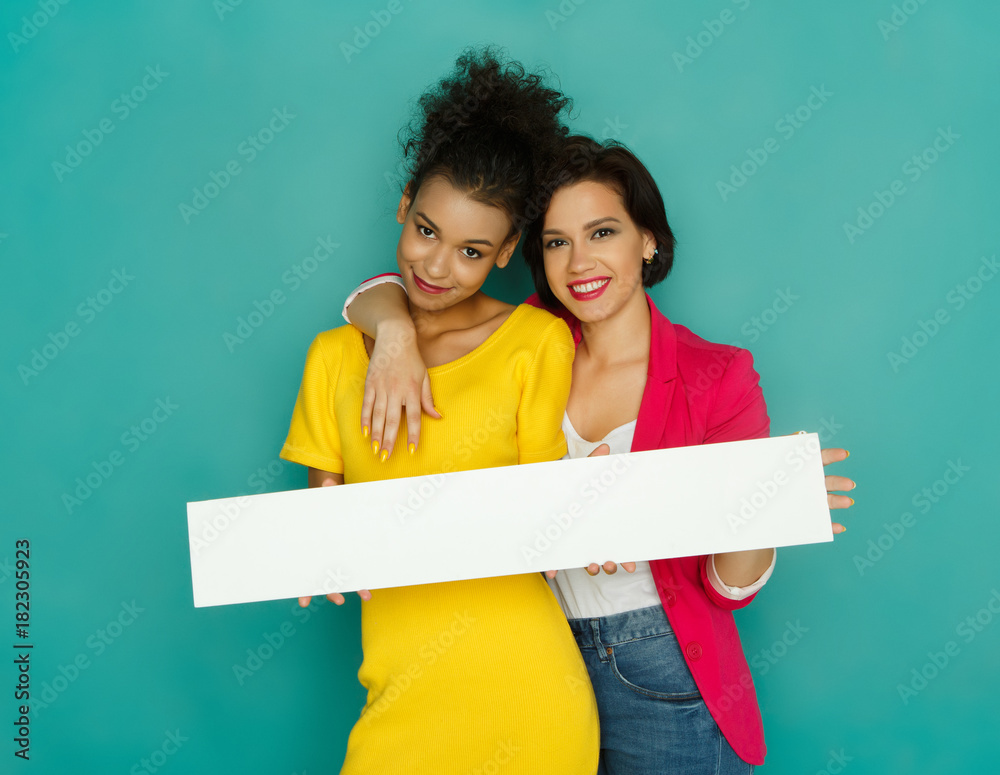 Girls holding blank white board at azur studio background Stock Photo ...