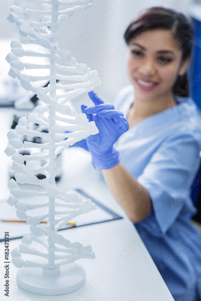 Evolution of genetics. Selective focus of a human DNA model standing on ...