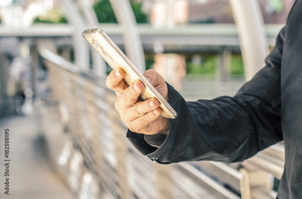 Close up of young business man using mobile smartphone blurry city ...