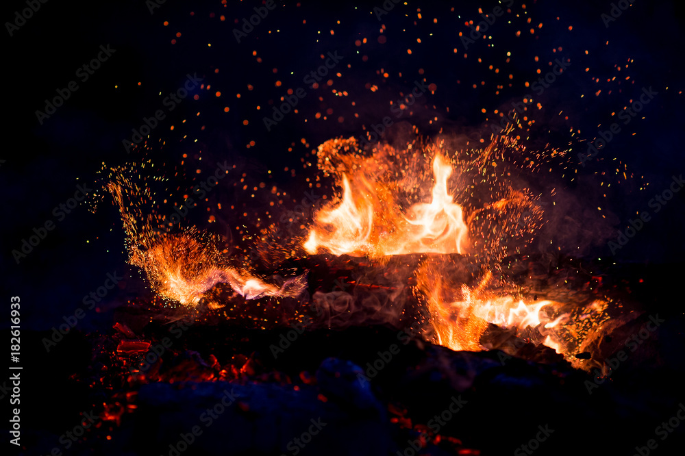 Burning woods with firesparks, flame and smoke. Strange weird odd ...