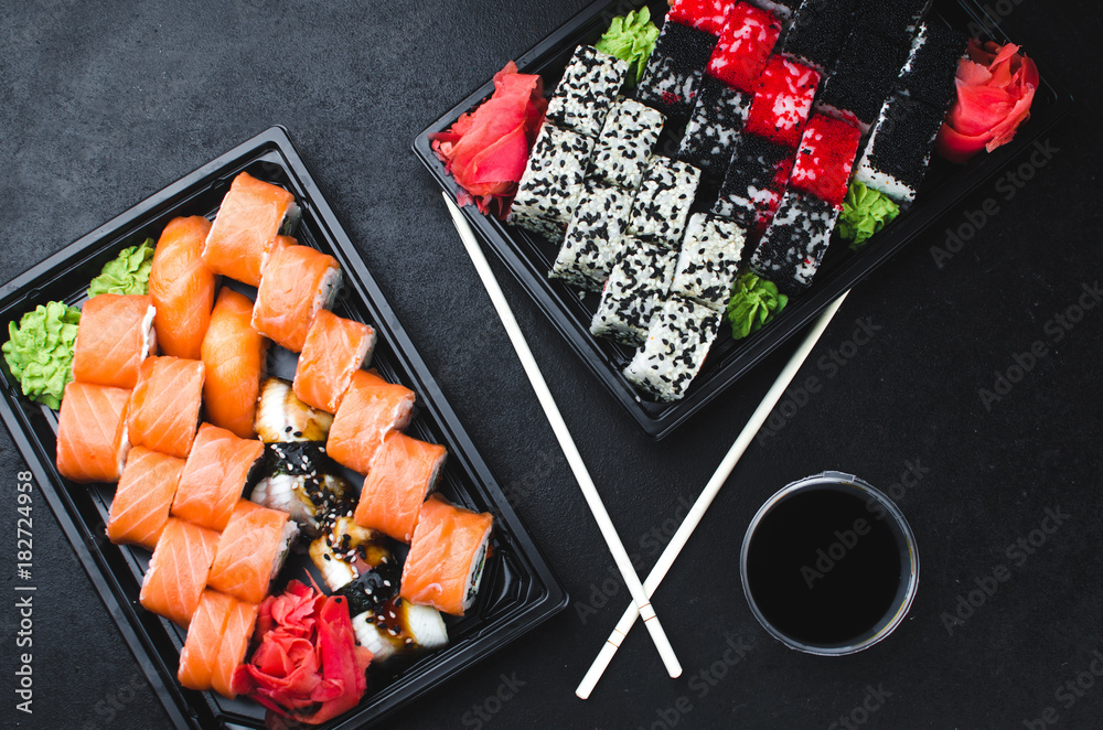 Sushi in a black container on a wooden table colorful and beautiful ...