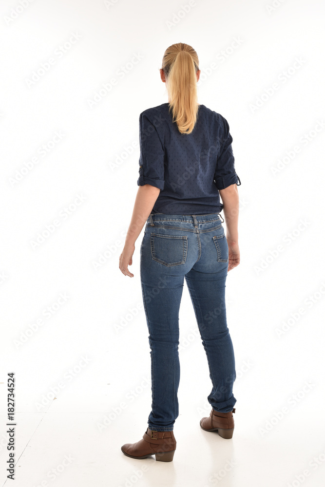 Full length portrait of a girl wearing simple blue shirt and jeans ...