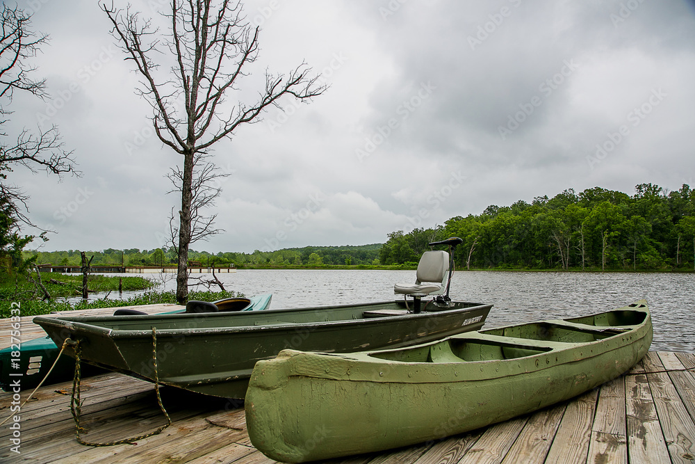 Boats and canoes on the dock by the lake Stock Photo | Adobe Stock
