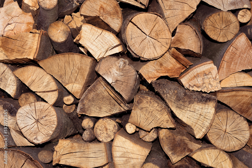 chopped log logs stacked in a drow log close-up as a background or ...