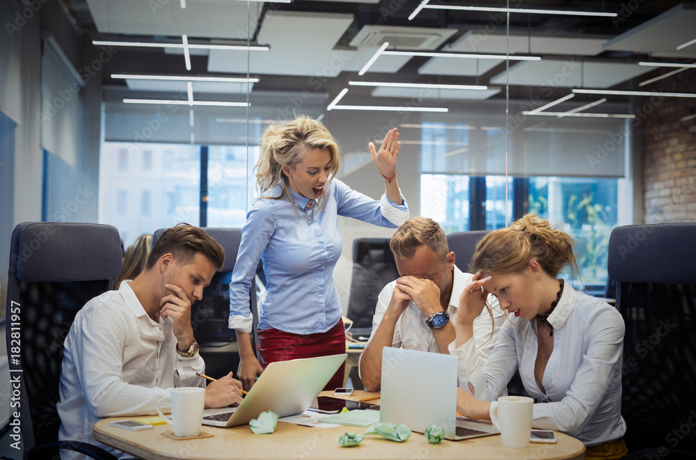 Angry female boss yelling to employees foto de Stock | Adobe Stock