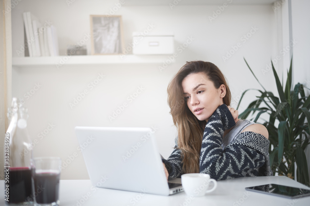Girl sitting on a chair in study room in the morning and using laptop ...