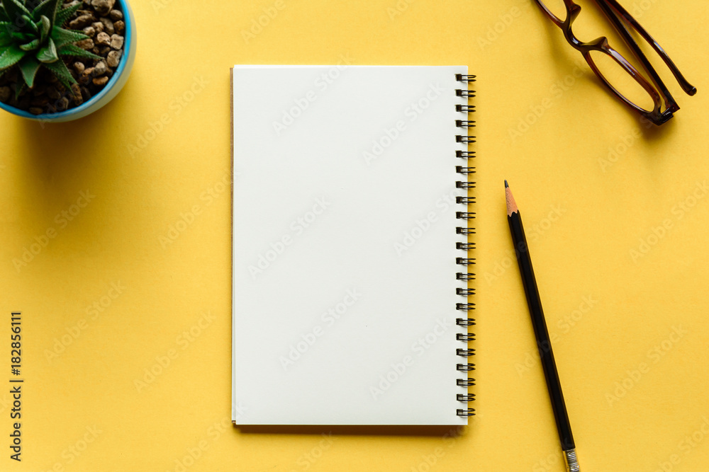 notebook and pencil on yellow desk Stock Photo | Adobe Stock