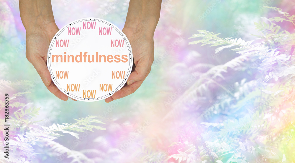 Mindfulness - do it NOW - female hands holding a NOW clock with ...