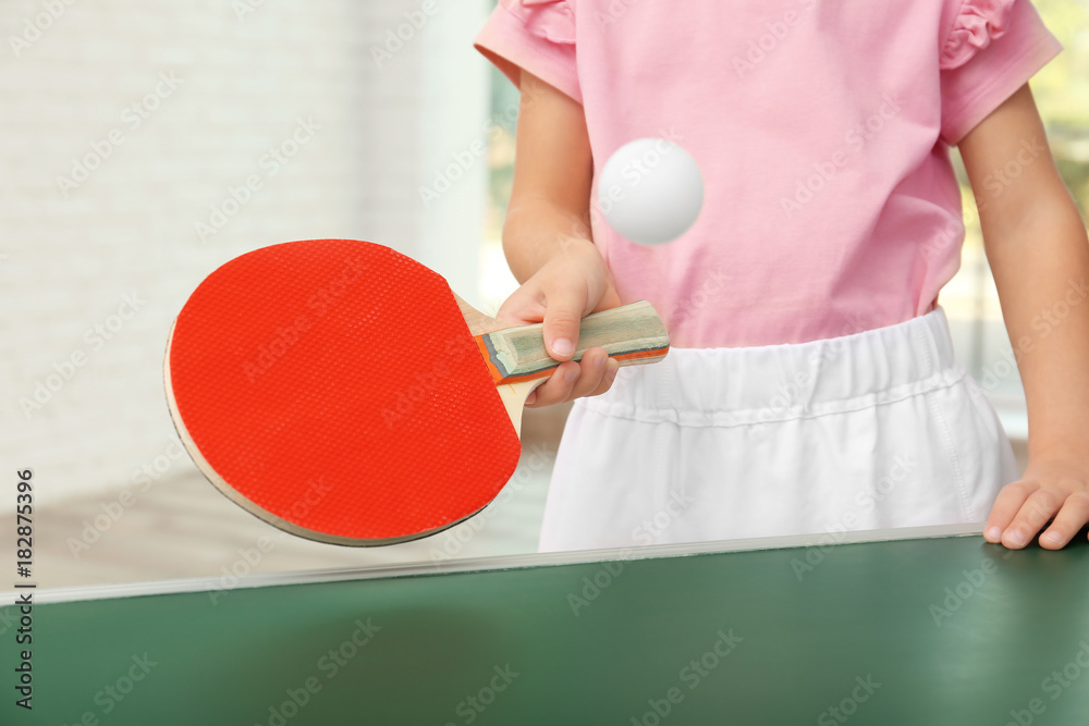 Cute little girl playing table tennis indoors Stock Photo | Adobe Stock