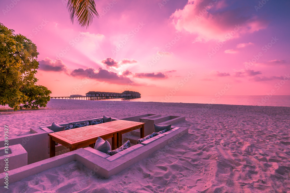 Amazing sunset sky in Maldives beach. Palm trees and luxury water villa ...