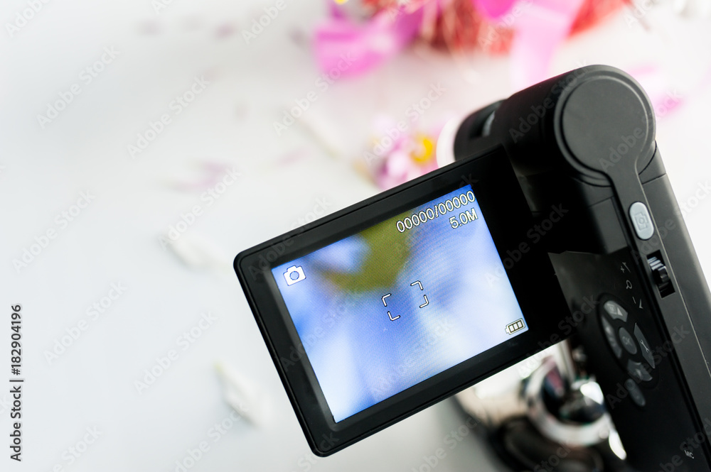 A digital microscope in a black case with an expanded screen on which ...