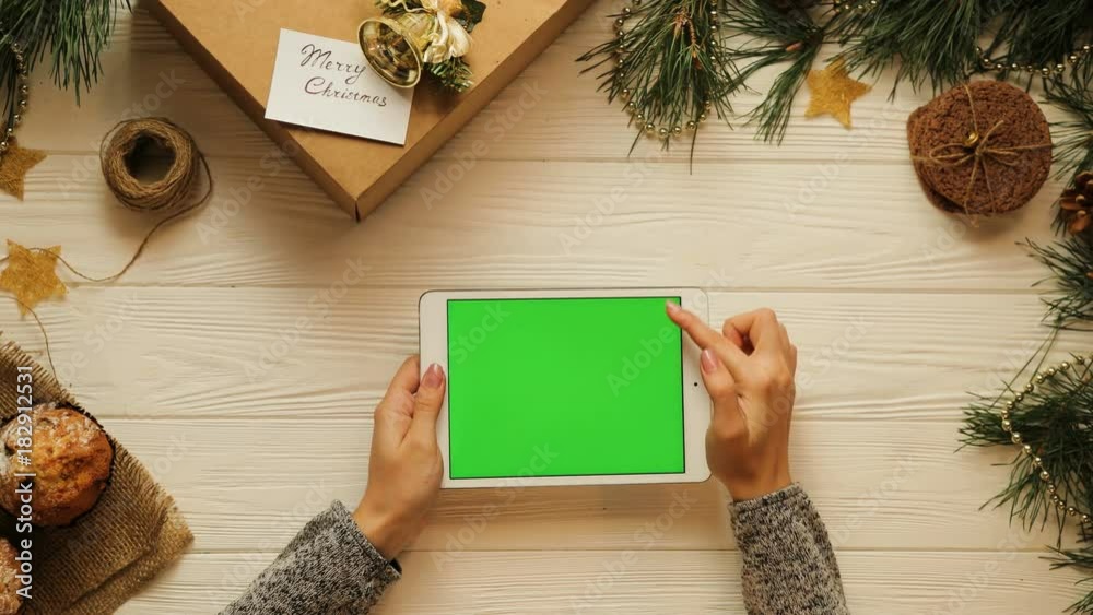Top view of Female hands tapping, scrolling and zooming on tablet ...