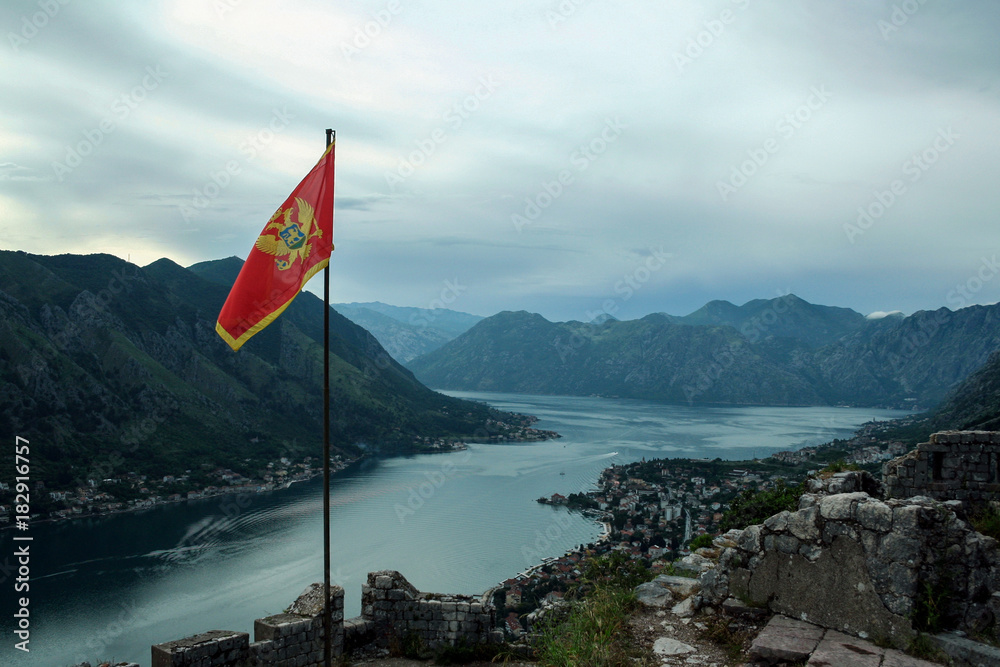 Flag of Montenegro taken in Kotor. The city and the Kotor bay can be ...