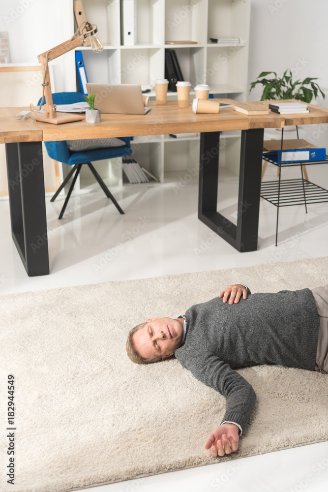 unconscious middle aged man lying on a floor in office Stock Photo ...