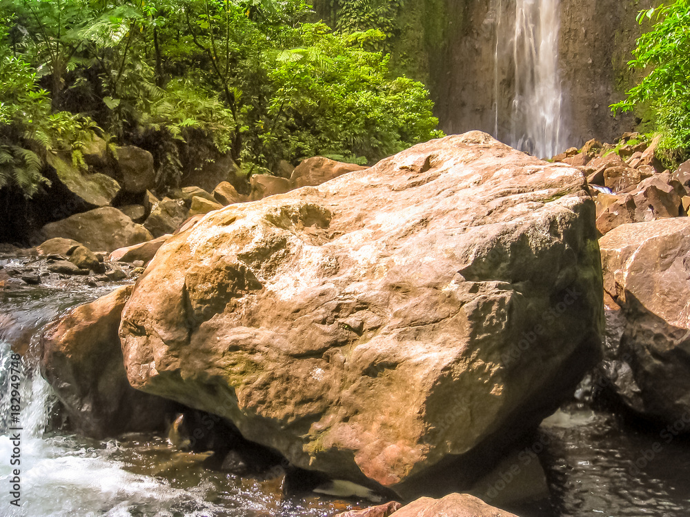 Closeup of rocks at the foot of Carbet Falls, one of three waterfalls ...