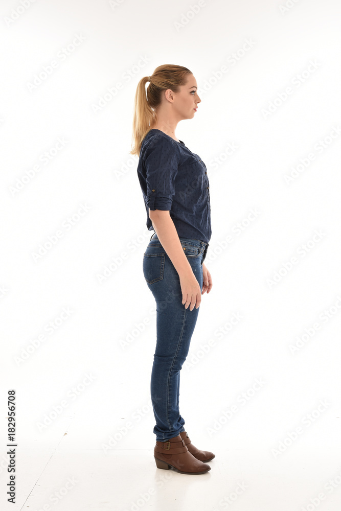 Full length portrait of a girl wearing simple blue shirt and jeans ...
