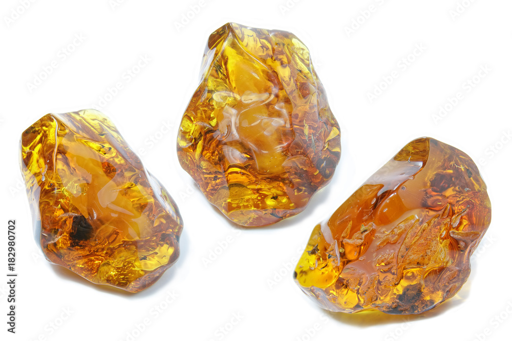 One piece of amber from different sides on a white background ...