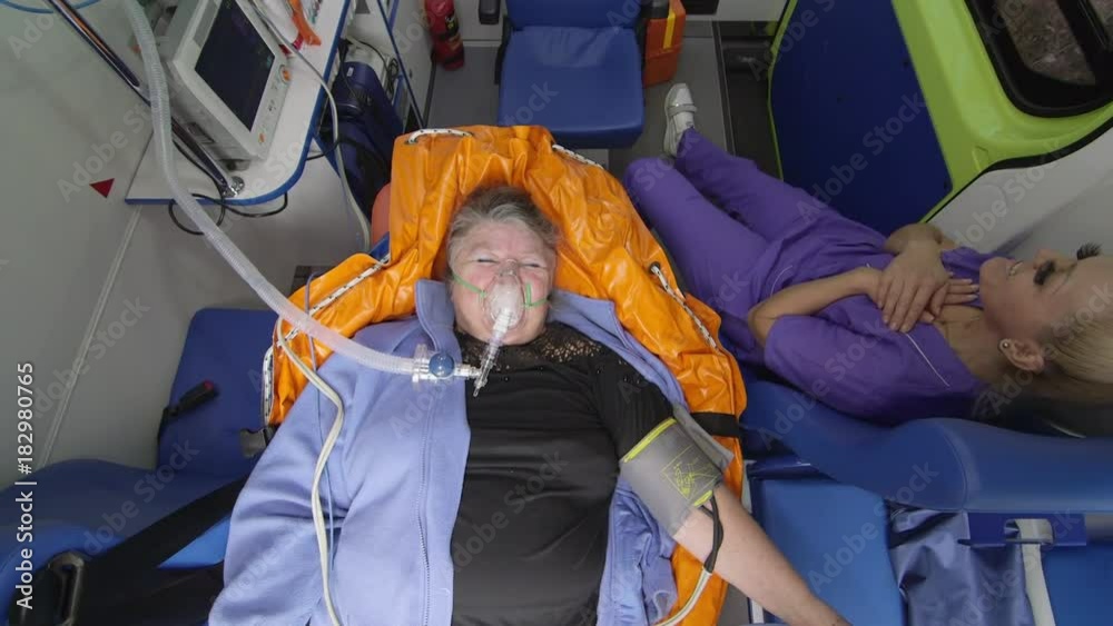 Emergency medical service. Paramedic and patient laughing together ...
