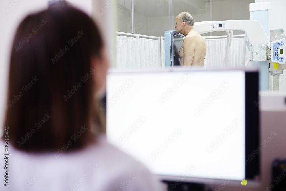 Shirtless senior man touching screen of x-ray machine by chest Stock ...