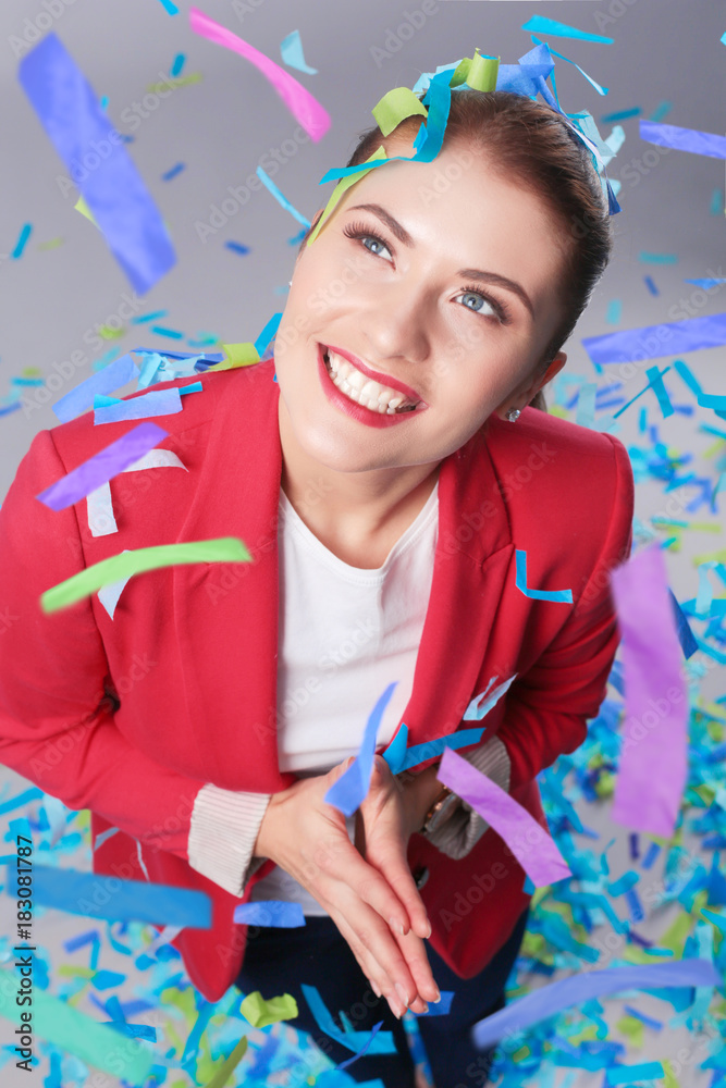 Beautiful happy woman at celebration party with confetti .Birthday or ...