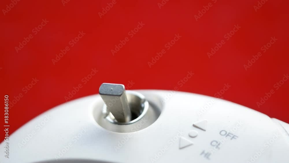 Hand holding a switch and turning the lever on-off. Close up, Shallow ...