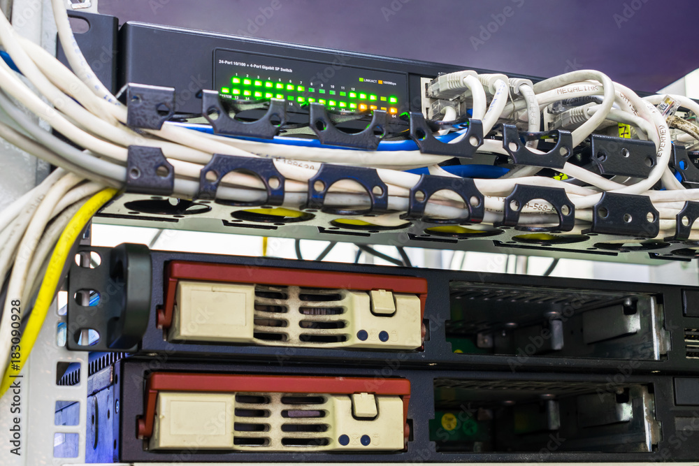 Multiple servers and a switch working in the server room. Multiple ...