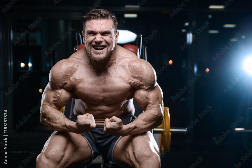 Brutal strong bodybuilder athletic men pumping up muscles with ...