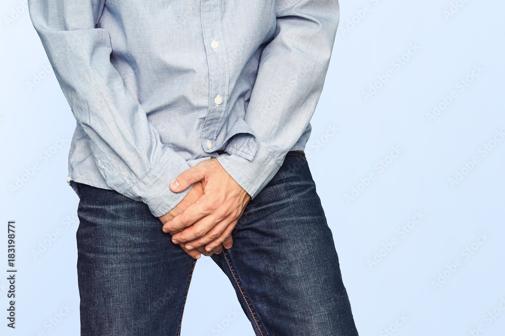 Close up of a man with hands holding his crotch Stock-Foto | Adobe Stock