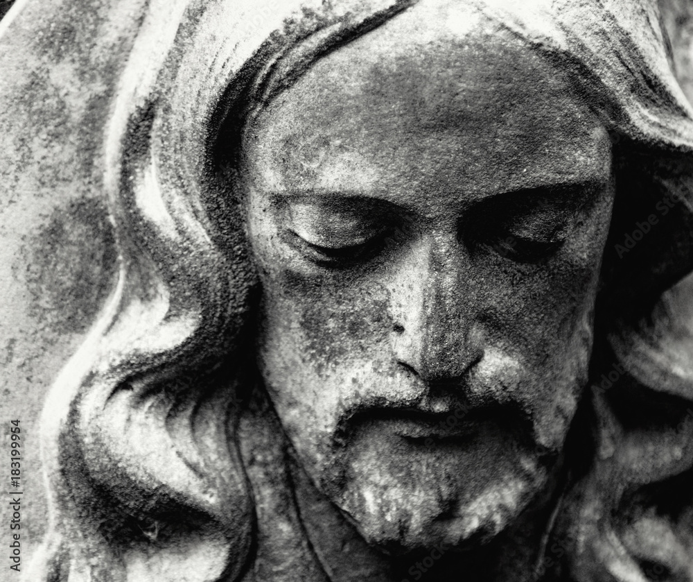 Jesus Christ ancient statue against a background of gray stone Stock ...