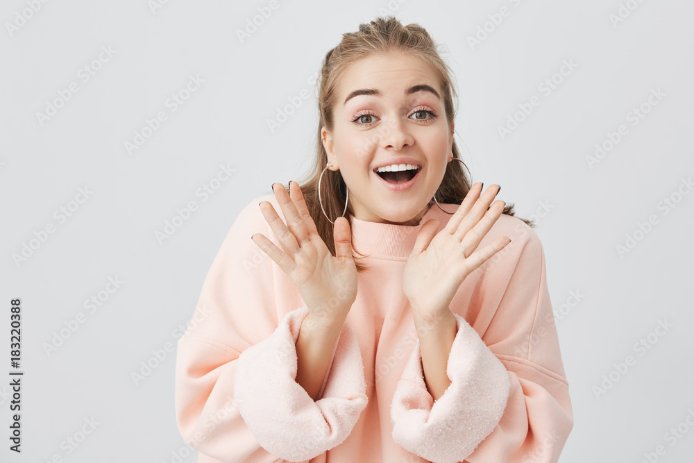 Surprised european girl with hands up amazed or shocked by unexpected ...