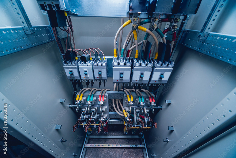 Wires and switches in electric box. Electrical panel with fuses and ...