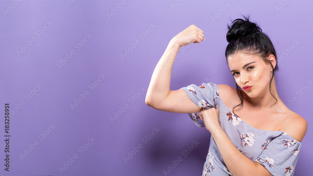 Powerful young woman in a success pose on a solid background Stock ...