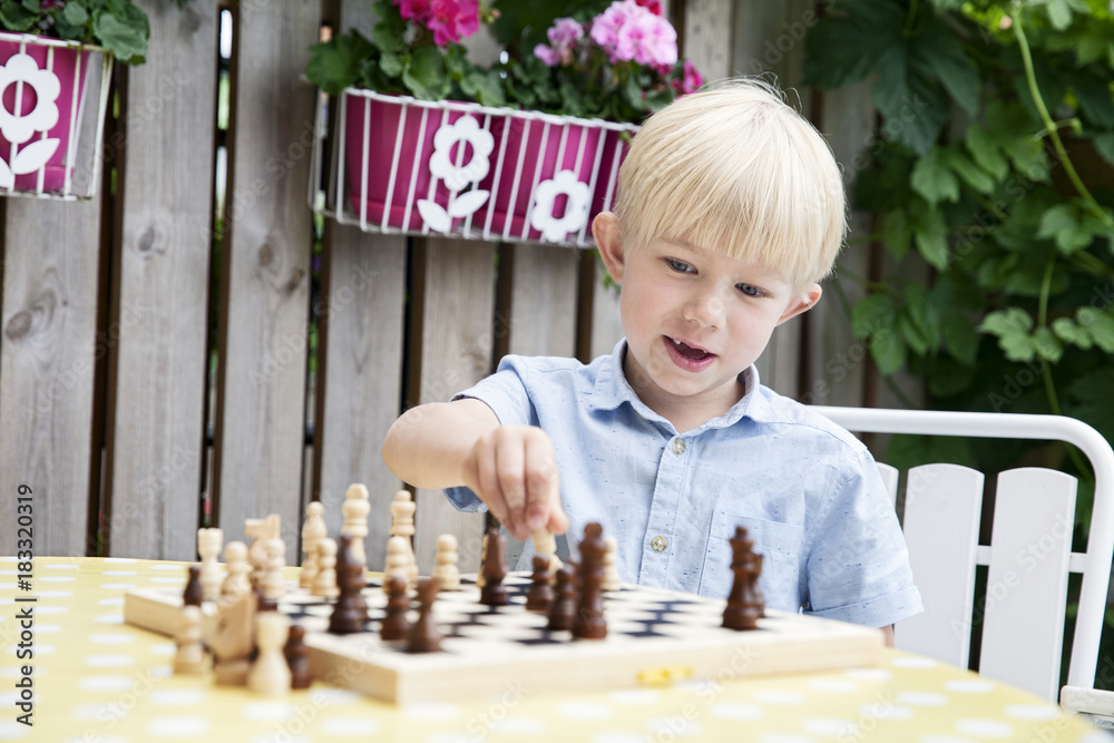 Boy playing chess Stock Photo | Adobe Stock