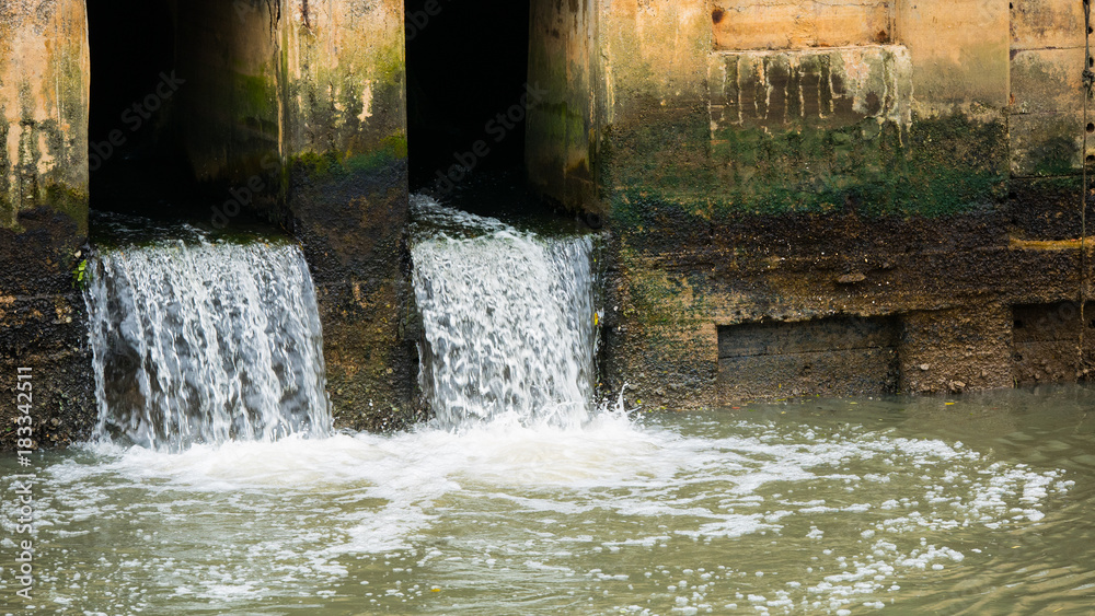 Water from a canal in the city is dropping down to the sea. To drain ...