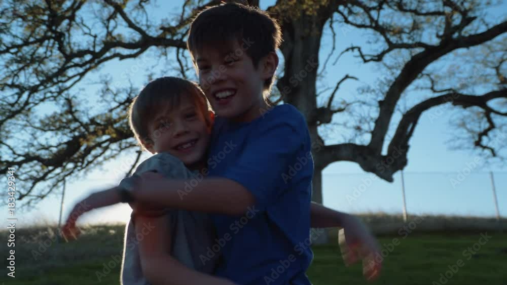 4k Two brothers best friends hugging and goofing off looking straight ...