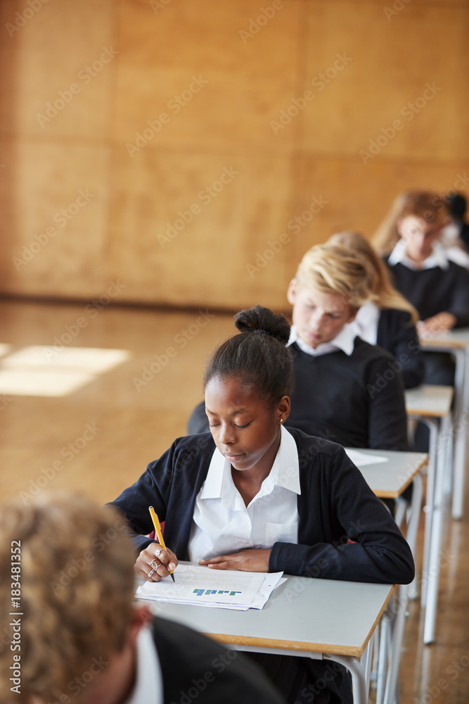 Teenage Students In Uniform Sitting Examination In School Hall Stock ...