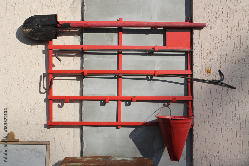 Red fire stand with fire extinguishing tools: conical fire buckets ...