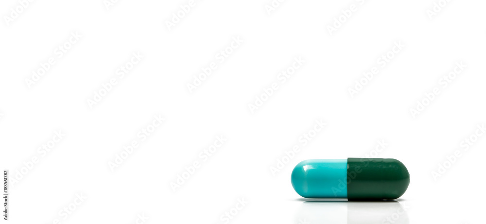 Blue, green antibiotics capsule pill isolated on white background with ...