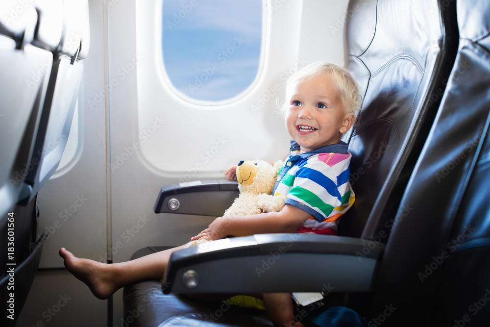 Child flying in airplane.Flight with kids. Stock Photo | Adobe Stock