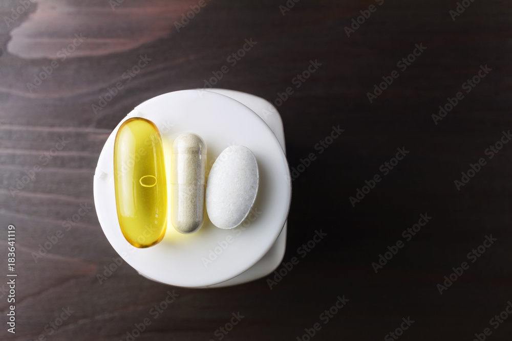 Complex of vitamins and dietary supplement, yellow capsule of omega 3 ...
