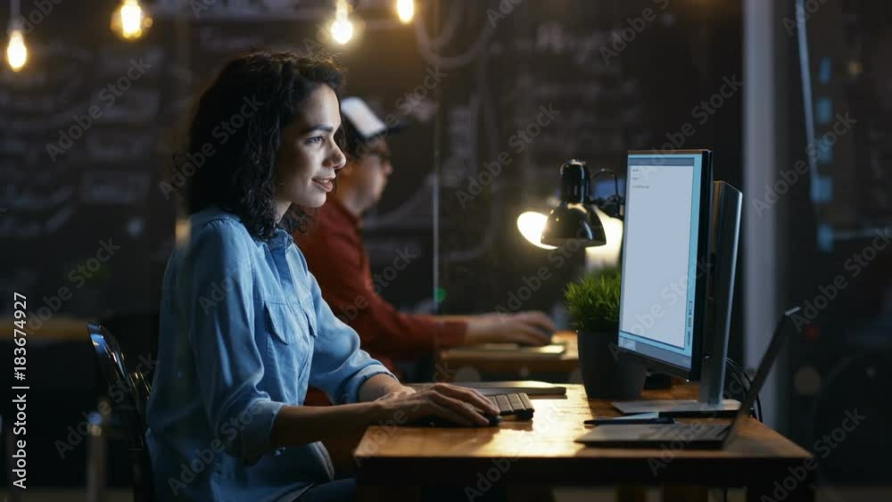 Beautiful Female Coder Works at Her Desktop on Her Peropnal Computer ...