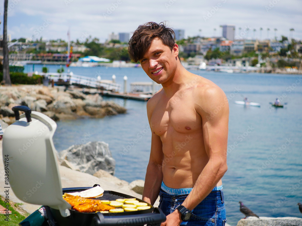 Young men cooking barbecue outdoor, handsome model, shirtless male with ...